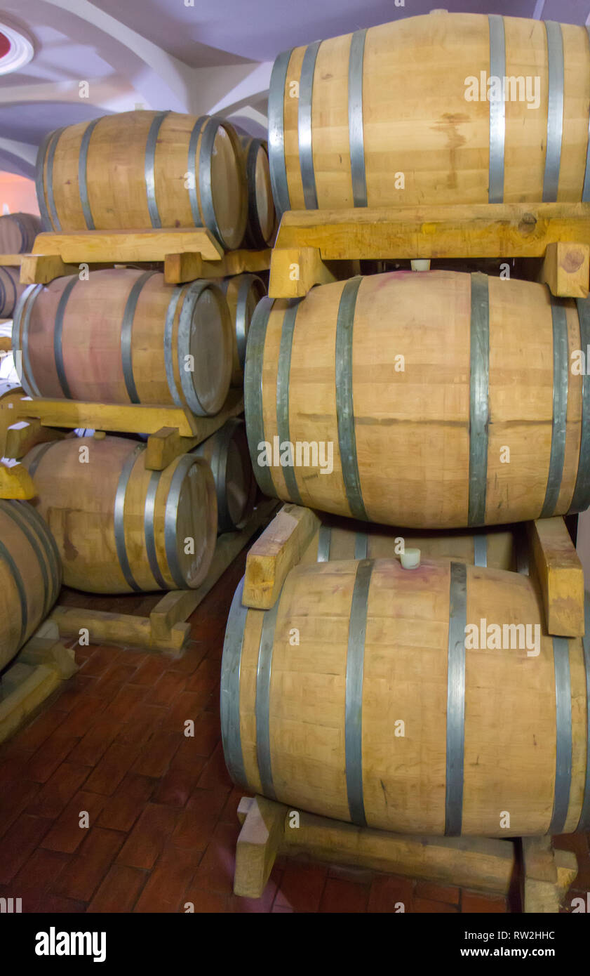 Wine barrels stacked in a old cellar at winery Stock Photo - Alamy