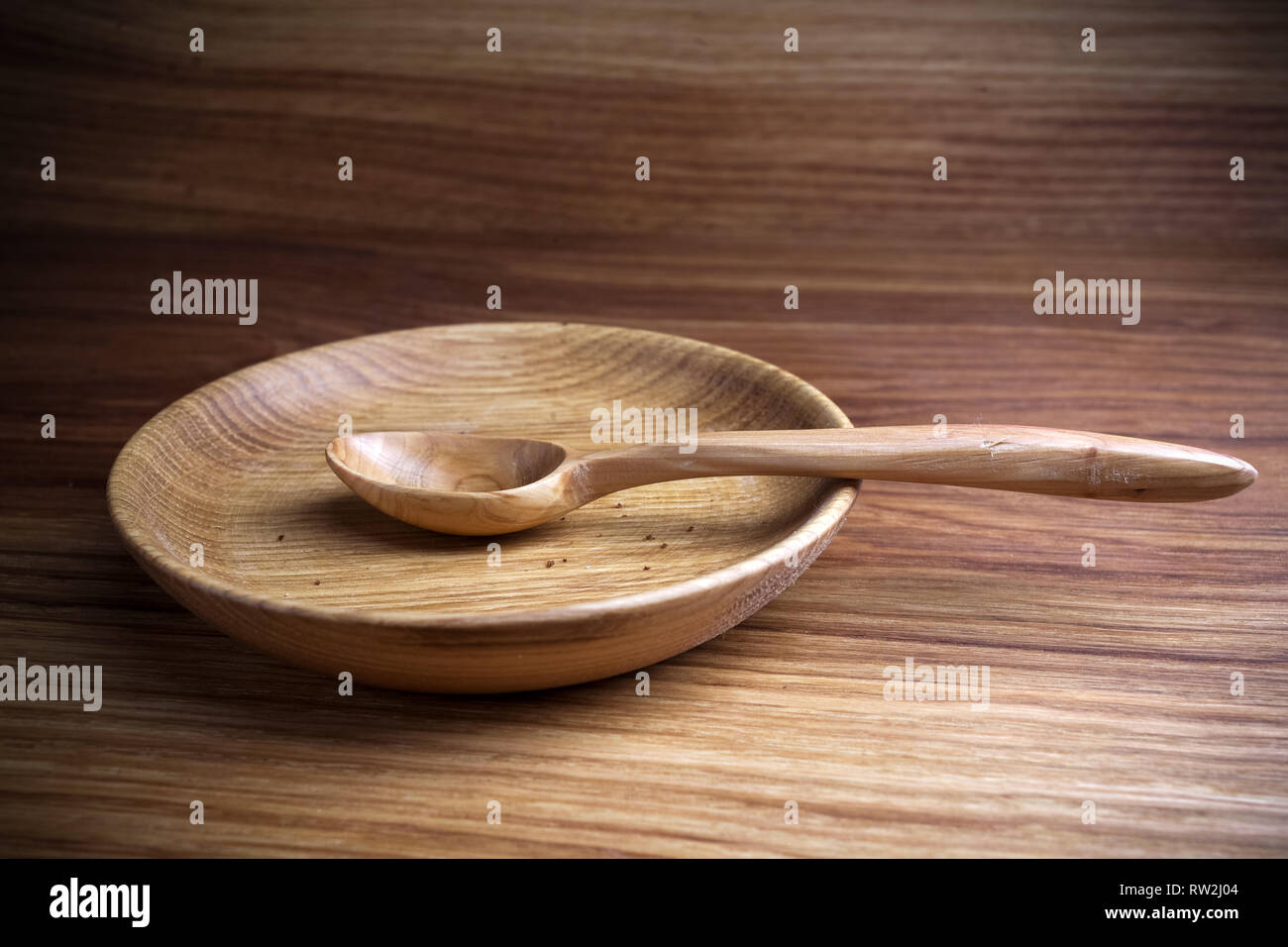 Fasting, Lent. Plate with spoon and crumb on wooden background Stock ...