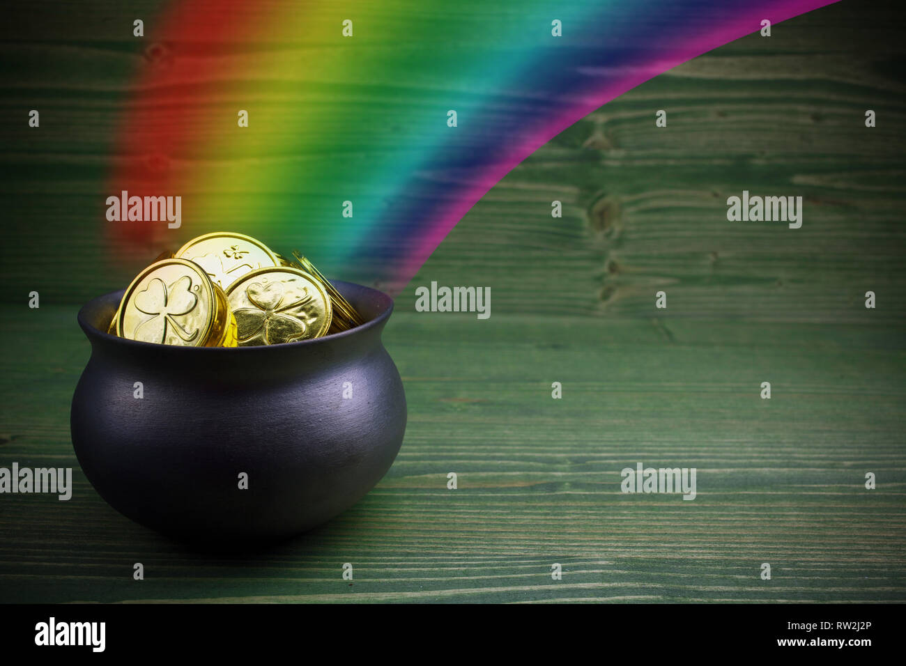 Pot Of Gold on green woden background. Magical Treasure with Rainbow ...