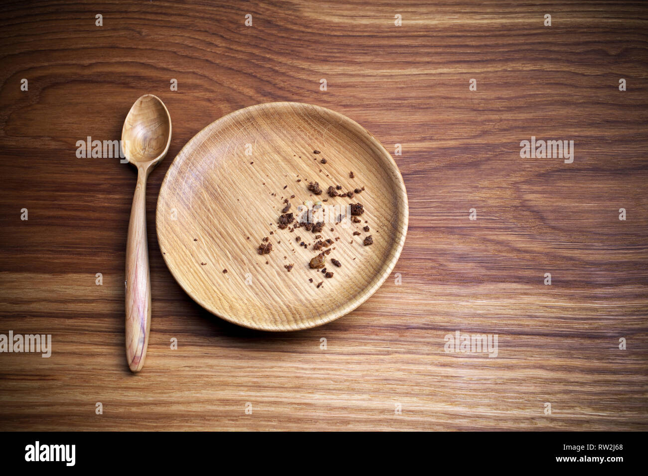 Fasting, Lent. Plate with spoon and crumb on wooden background Stock ...