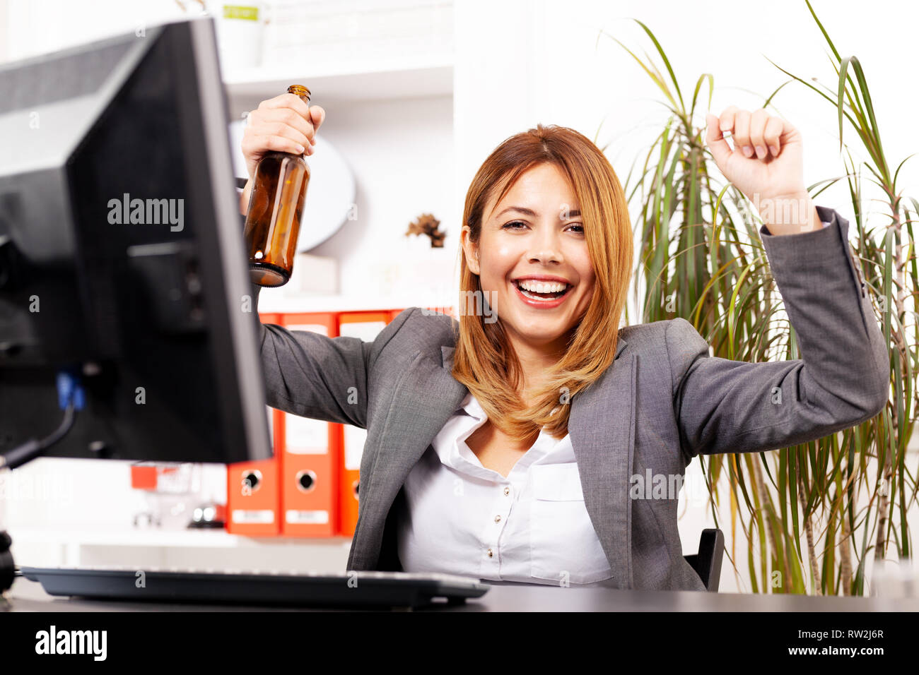 drunk business woman drinking beer in an office Stock Photo - Alamy