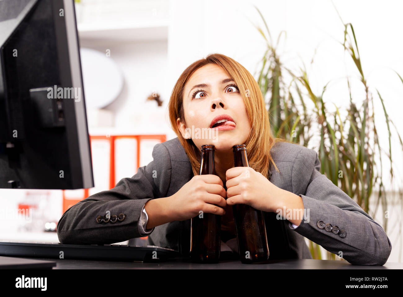 drunk business woman drinking beer in an office Stock Photo - Alamy