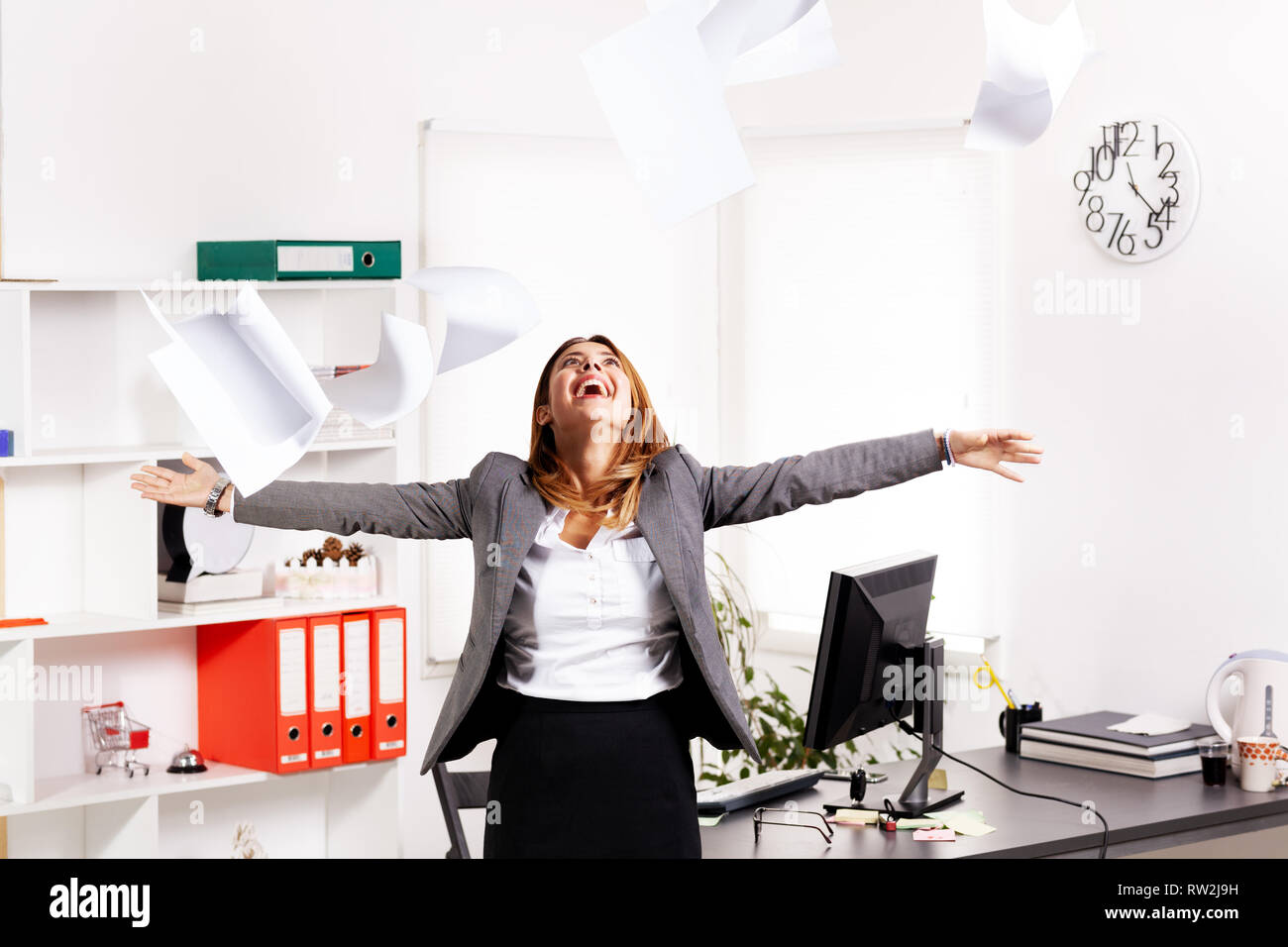 happy businesswoman in an office throwing papers Stock Photo - Alamy