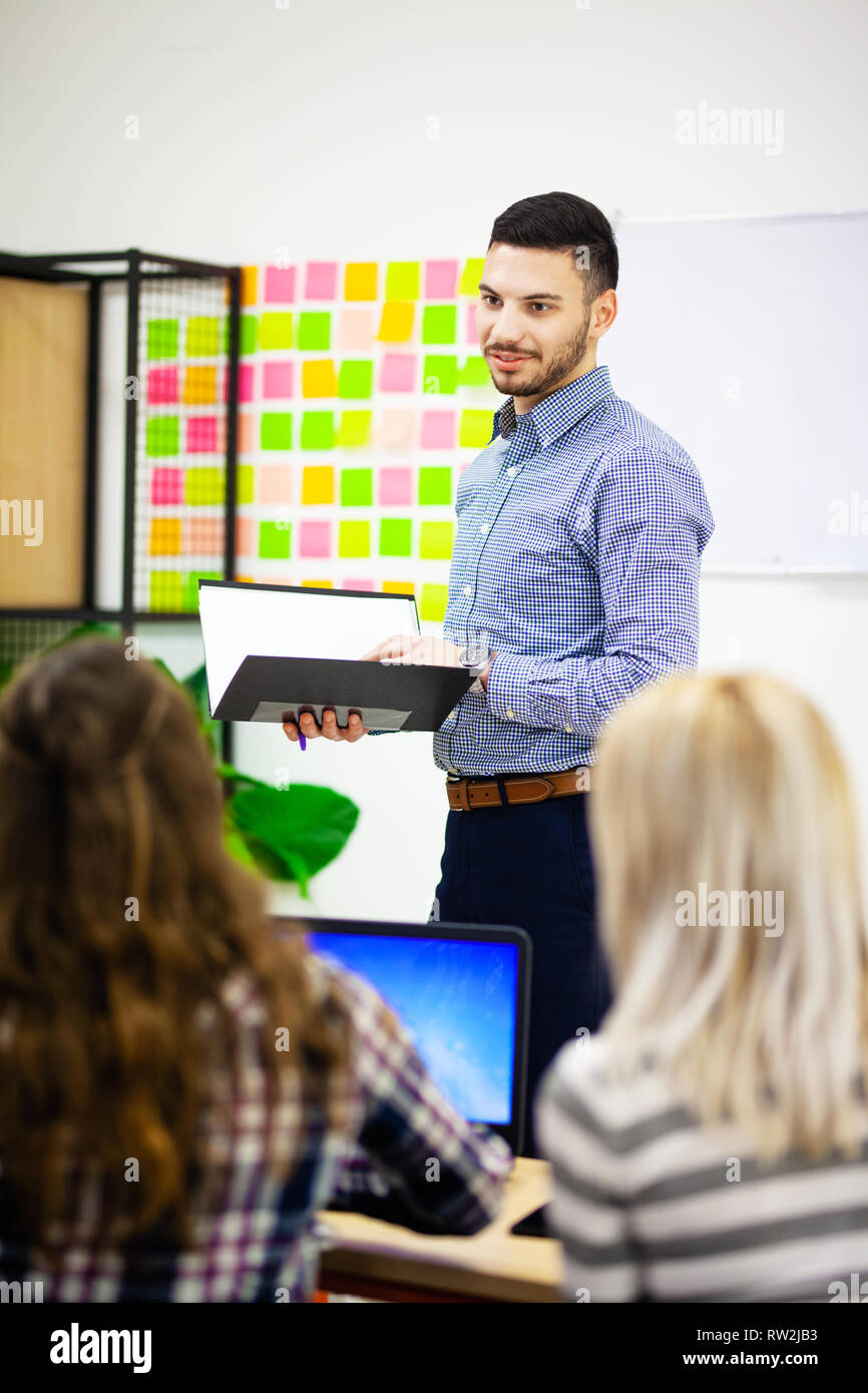 professor talking to young students in a modern classroom Stock Photo ...