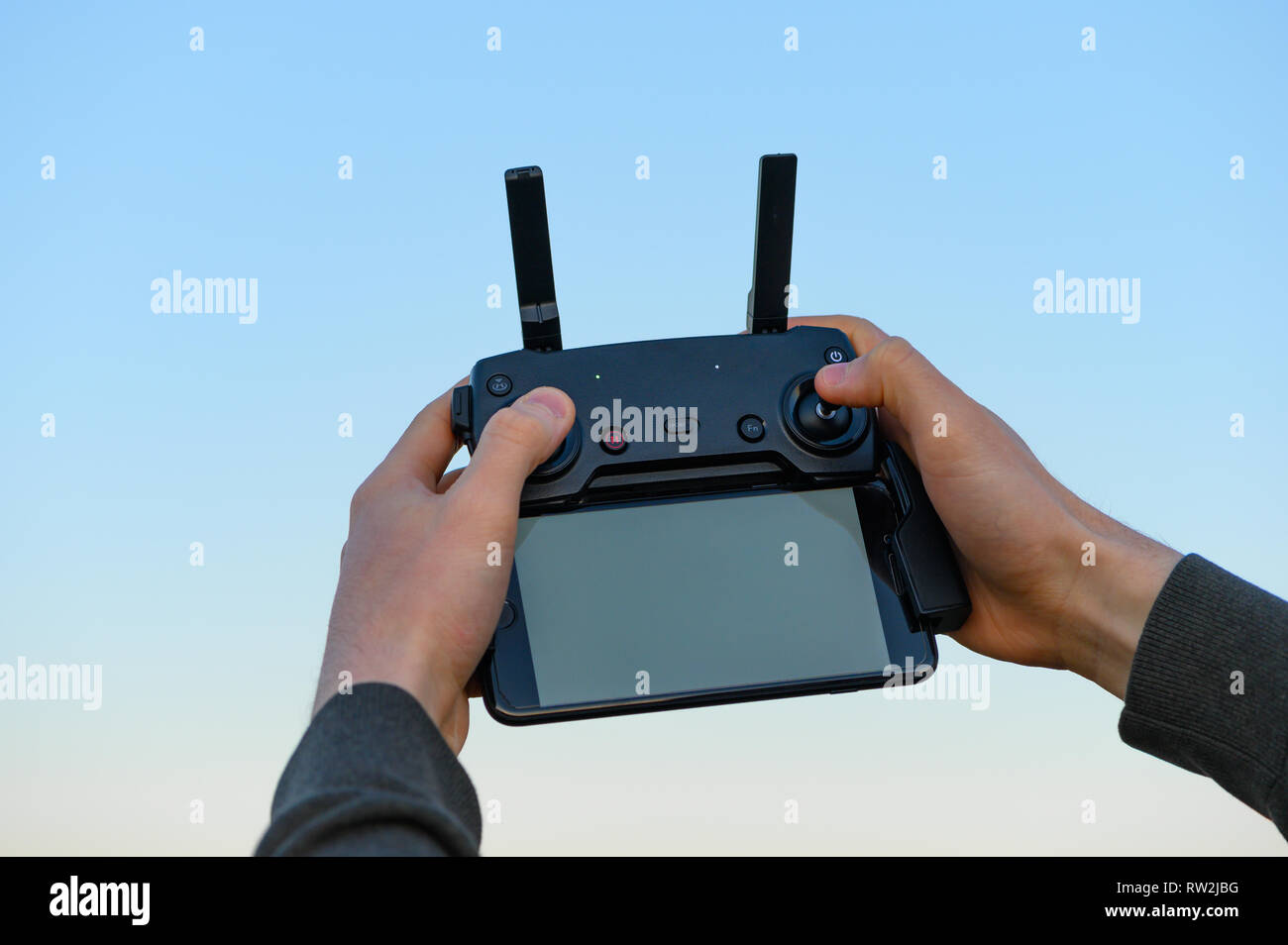 Man holds the remote control Stock Photo - Alamy