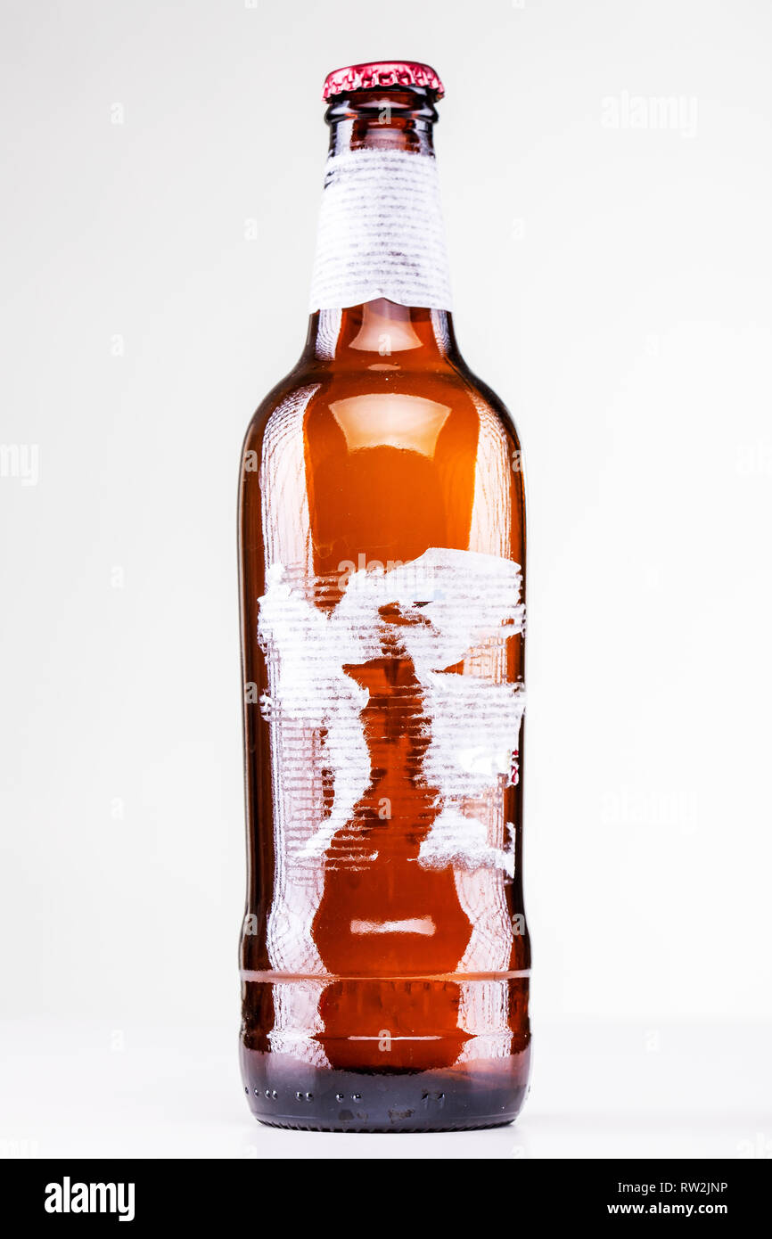 beer bottle with torn label isolated on white Stock Photo - Alamy