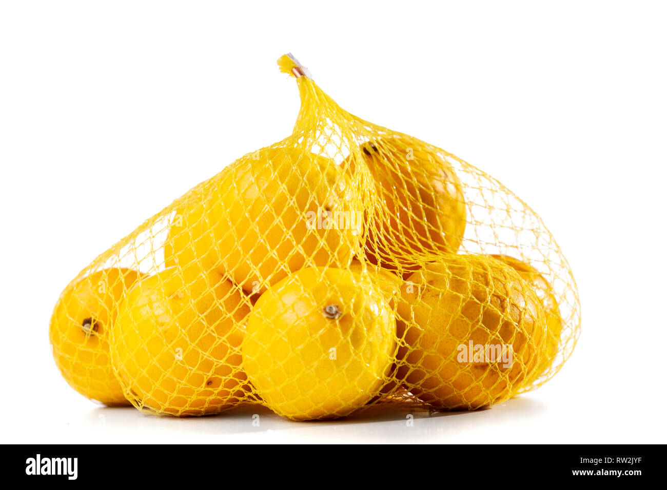 group of ripe lemons in a mesh bag against white background Stock Photo ...