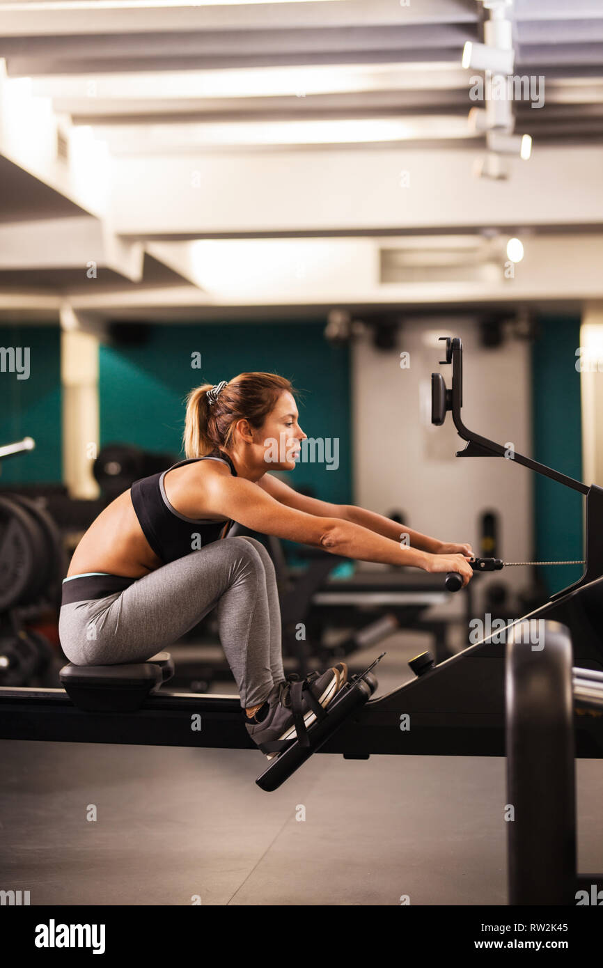 fitness girl working out on a gym machine Stock Photo - Alamy