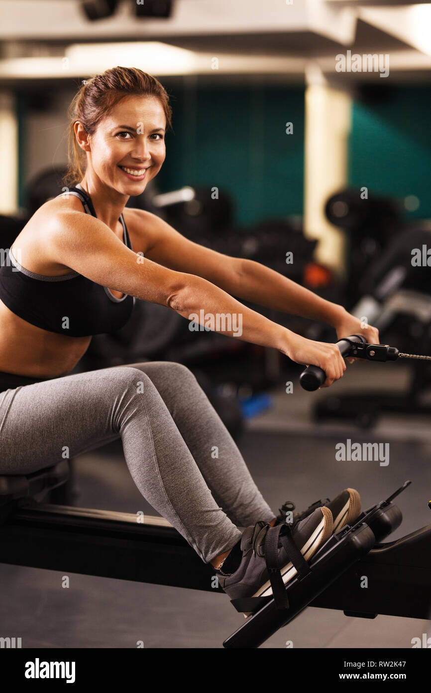 fitness girl working out on a gym machine Stock Photo - Alamy