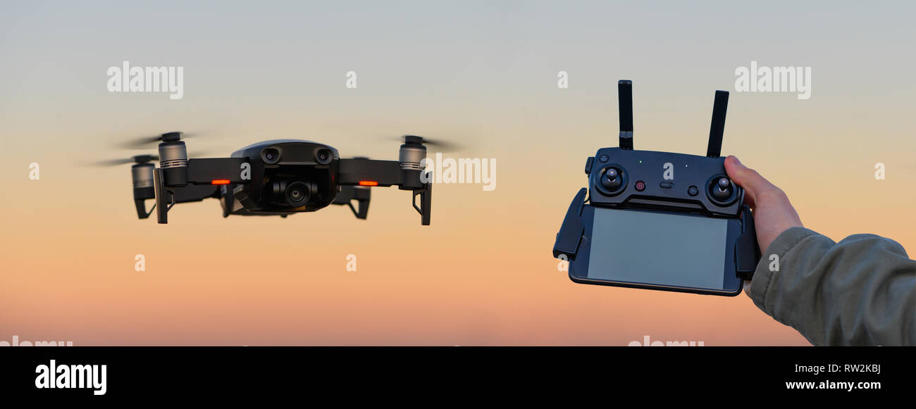 Drone in the sky with remote controller Stock Photo - Alamy