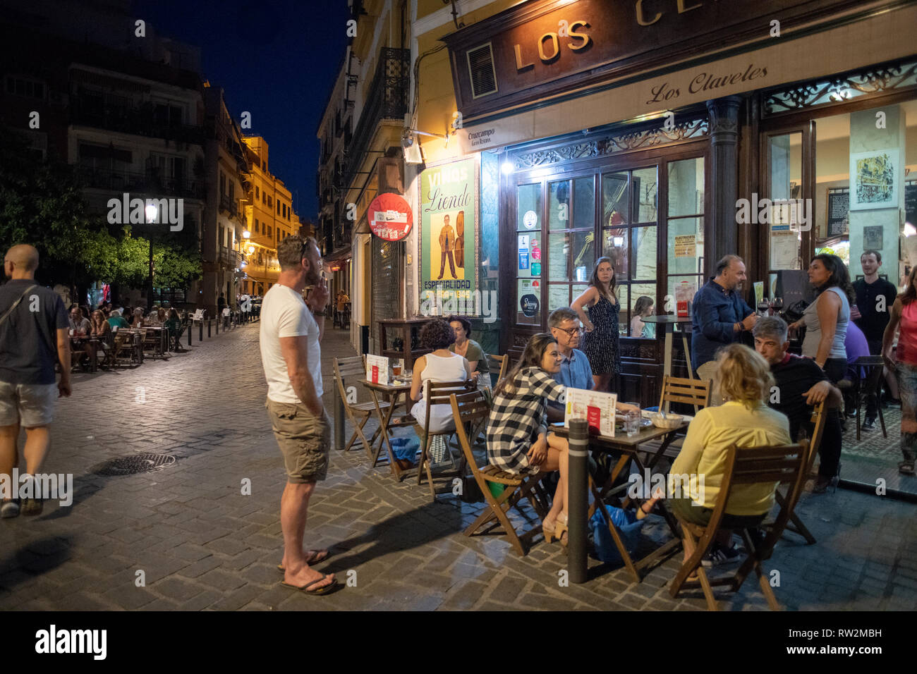 People relaxing at night in Seville , Spain Stock Photo - Alamy