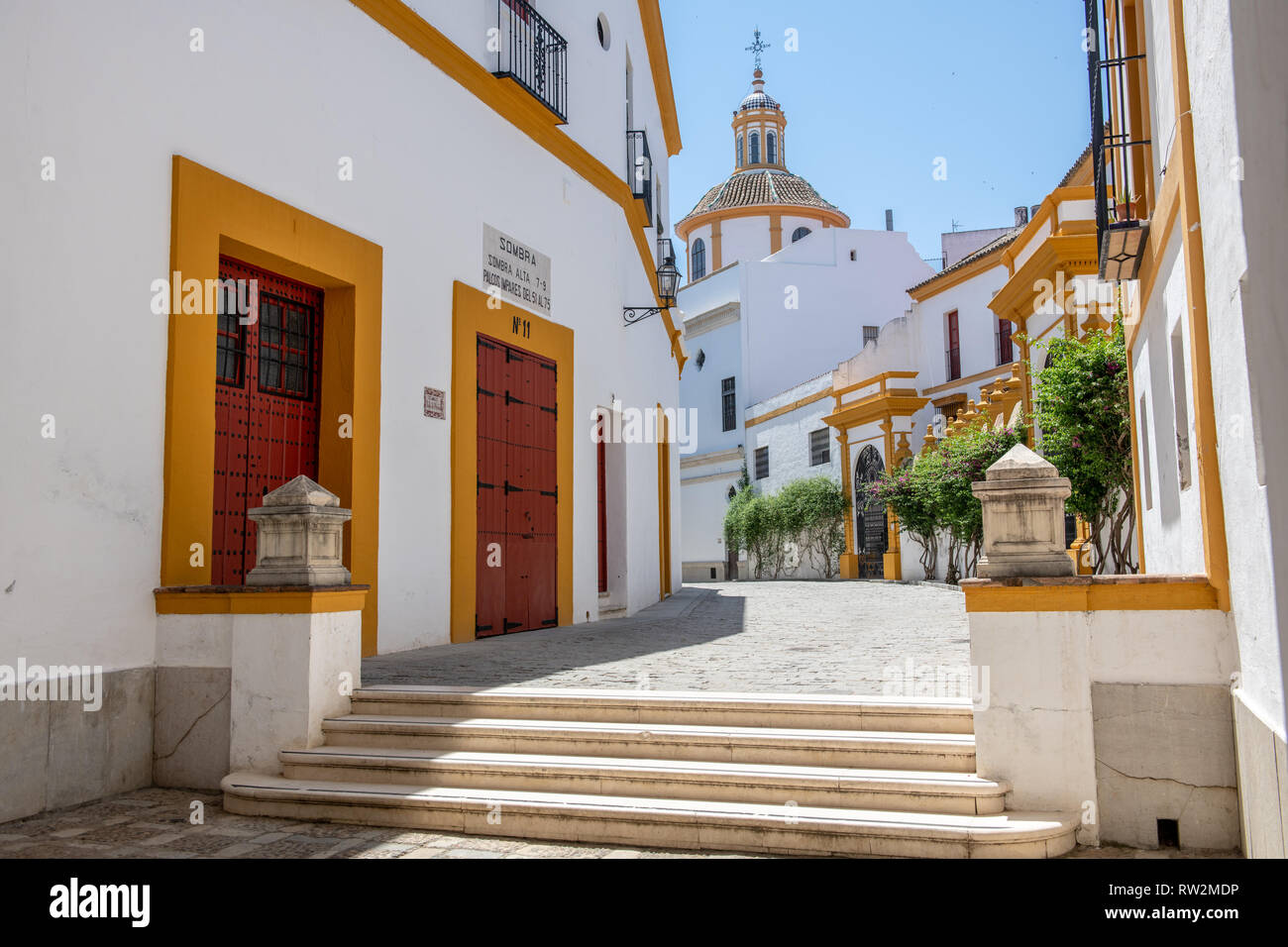 A colorful buildings line pedestrian street in Seville , Spain Stock ...