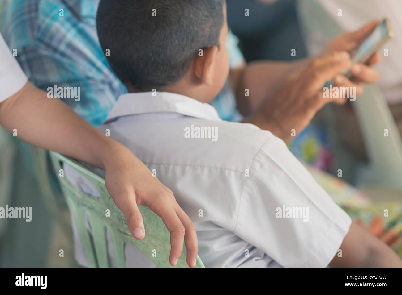 Mom and Her son using smartphone together in school Stock Photo - Alamy