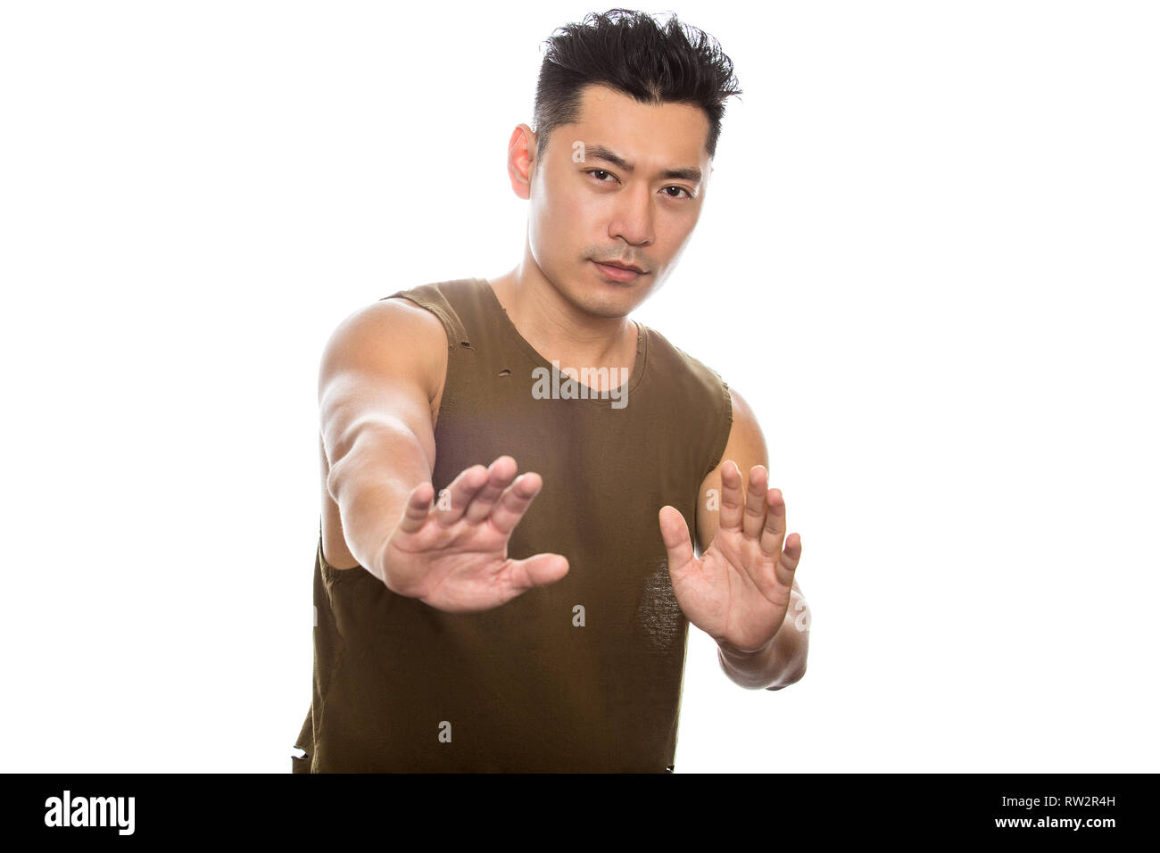 Athletic Asian male with trendy torn sleeveless shirt on a white ...