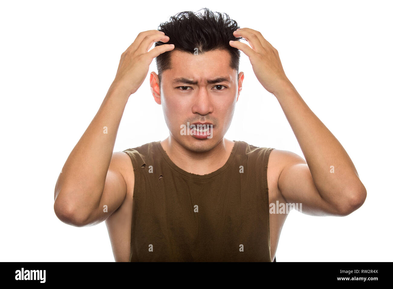 Athletic Asian male with trendy torn sleeveless shirt on a white ...