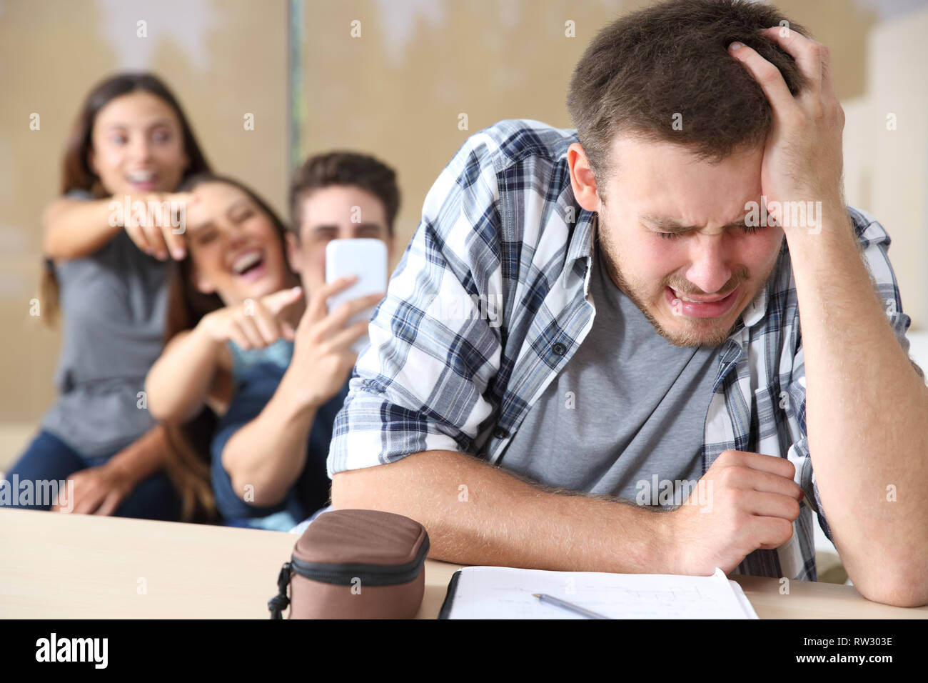 Sad teen complaining suffering cyber bullying from his mates Stock ...