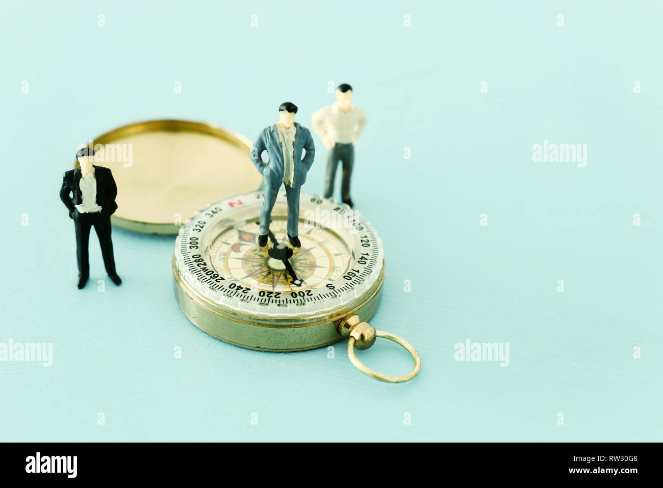 leadership and teamwork concept miniature people and compass ...
