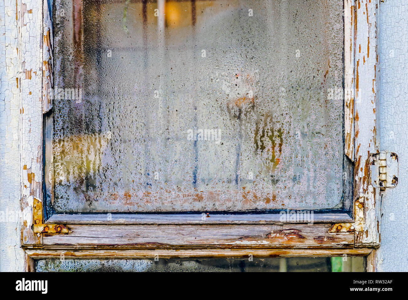 Part of ancient window with condensation on the dirty glass in the old ...