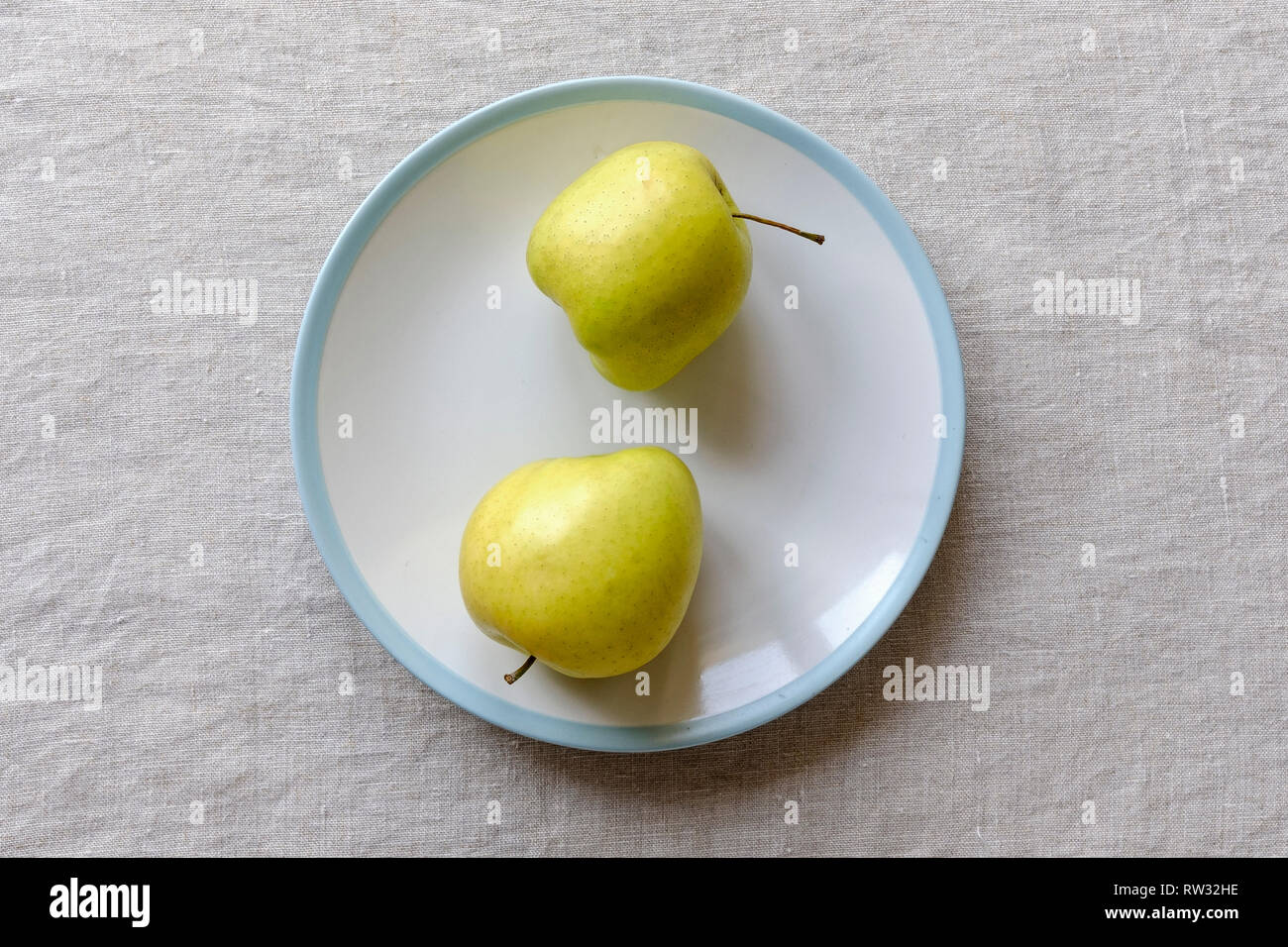 Ugly food concept with misshapen fresh healthy juicy golden apples on a ...