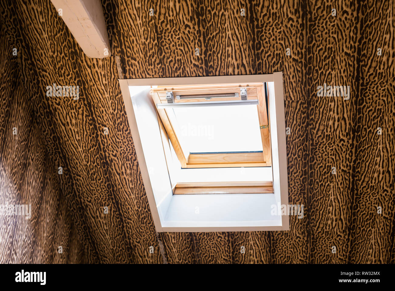 In the attic an apartment. Small window applied to the sloped ceiling ...