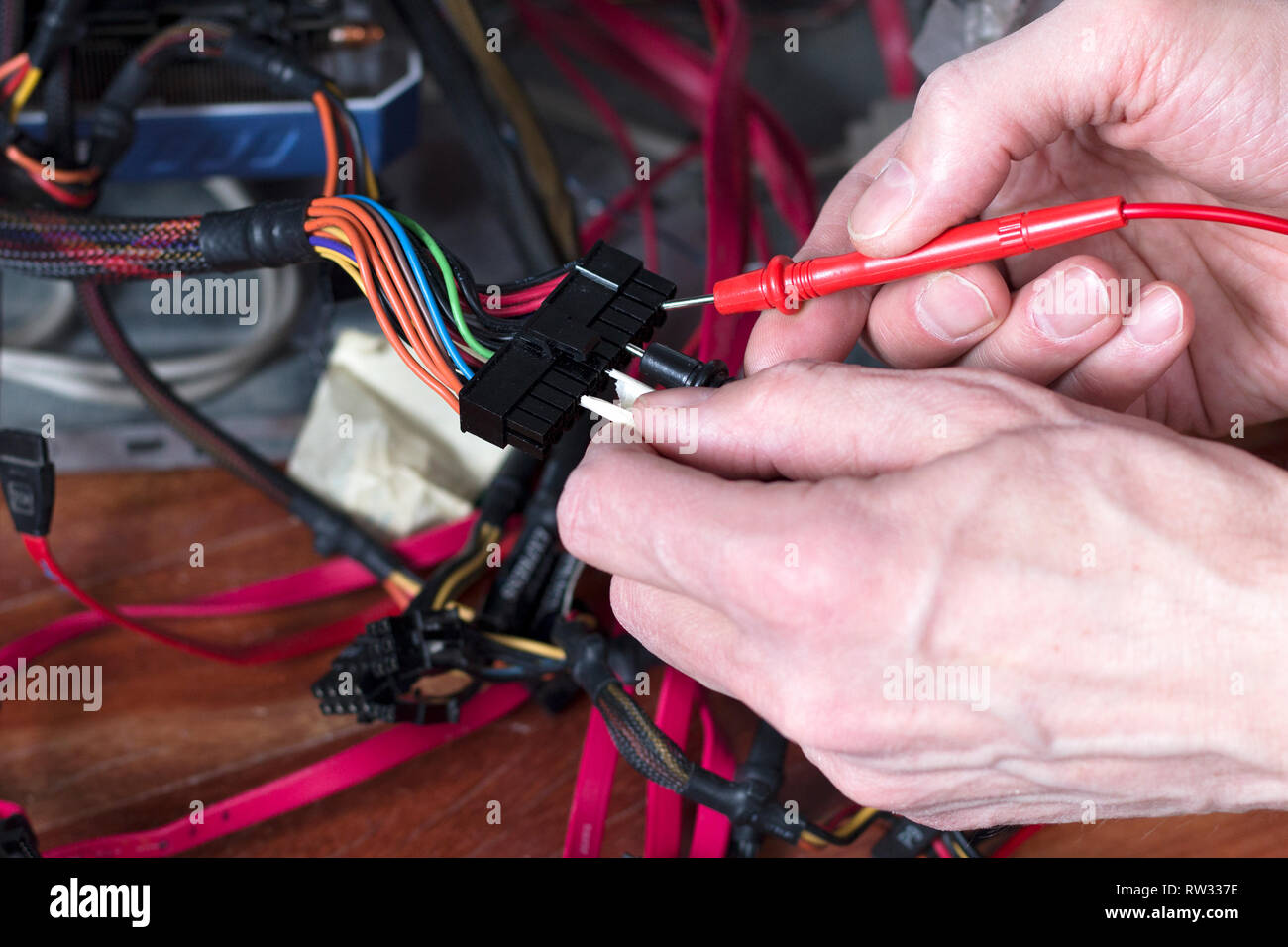 Technician equipment repair. A man checks the electrical power of ...