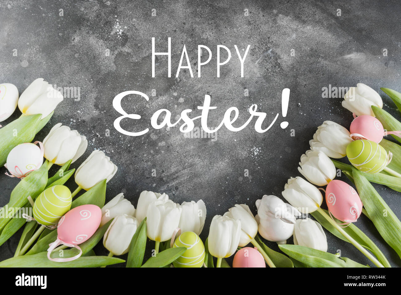 Happy Easter. Border of white tulips, colorful eggs on vintage gray ...