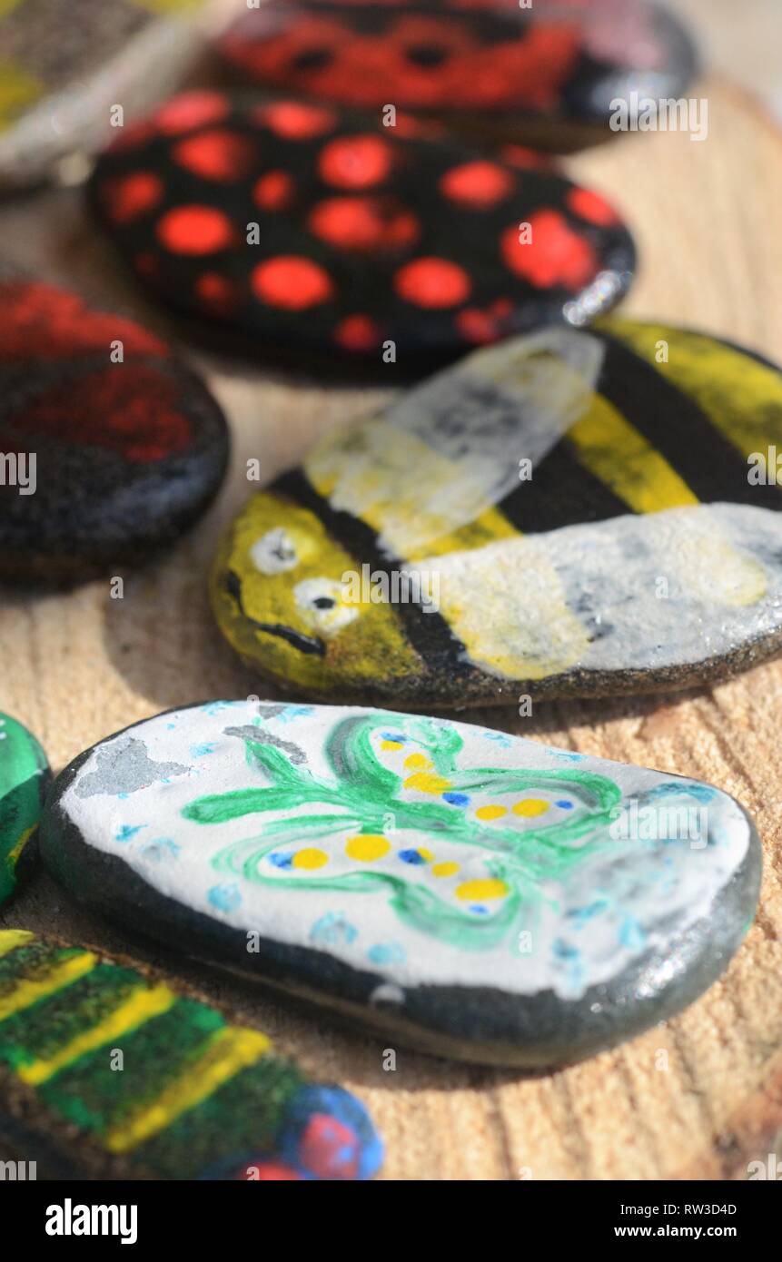 Painted pebble insects Stock Photo - Alamy
