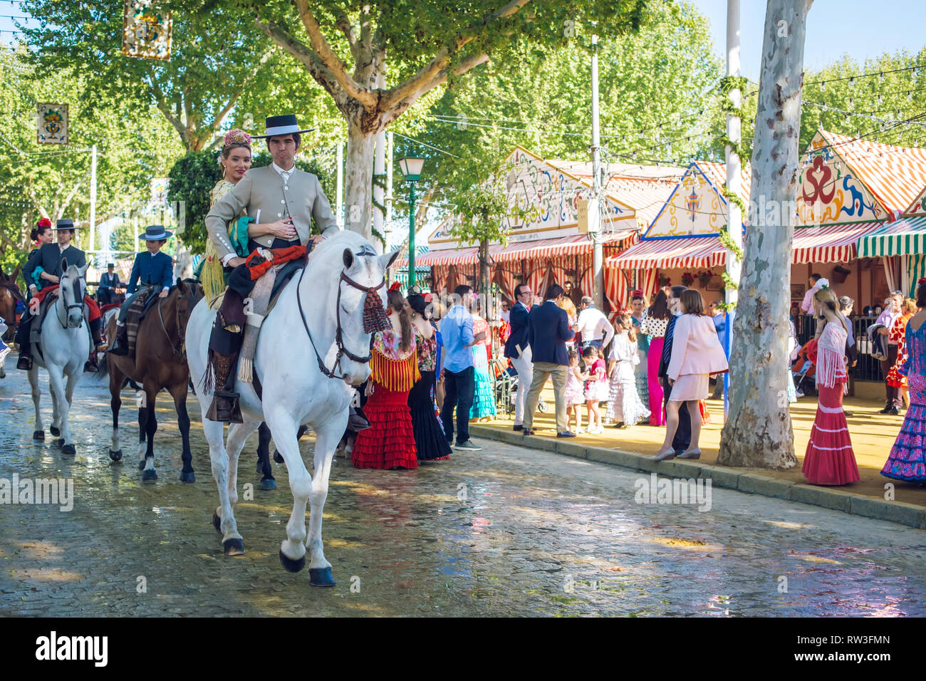 Riders and People dressed in traditional costumes enjoy April Fair ...