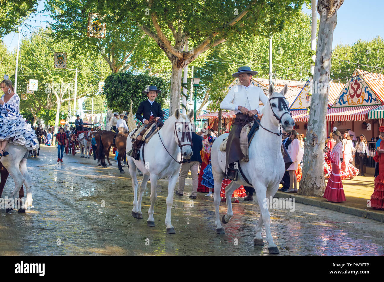 Riders and People dressed in traditional costumes enjoy April Fair ...