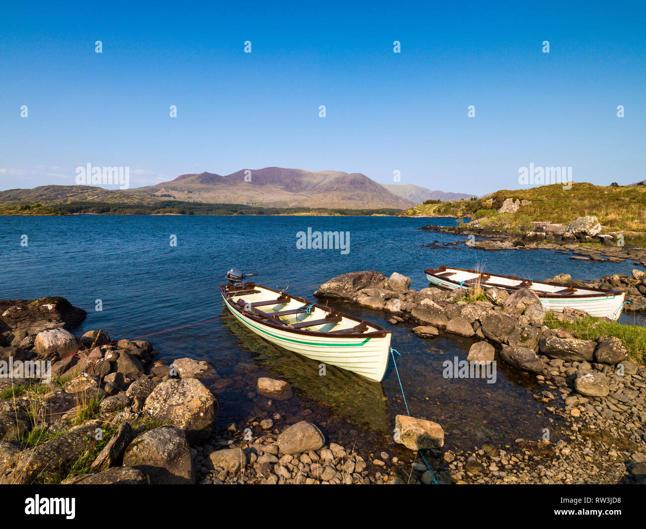 Two boats on the shore of Lough Currane near Waterville on the Ring of ...