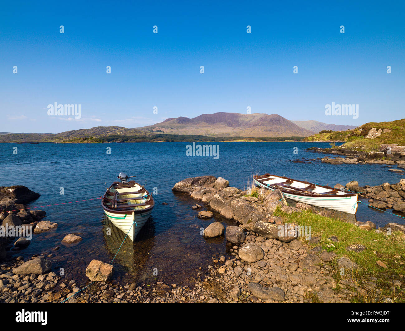 Two boats on the shore of Lough Currane near Waterville on the Ring of ...