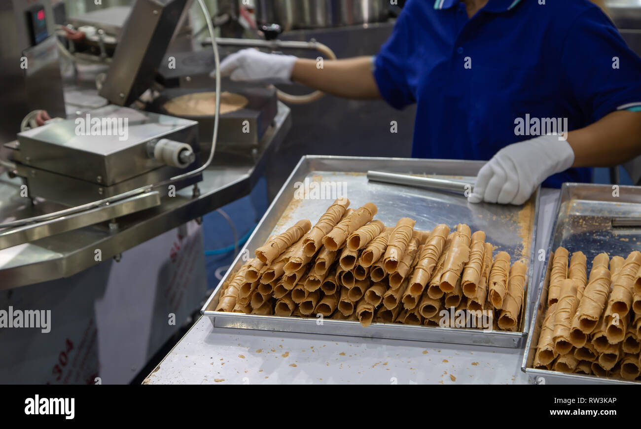 Food worker made coconut crispy roll biscuit Stock Photo - Alamy