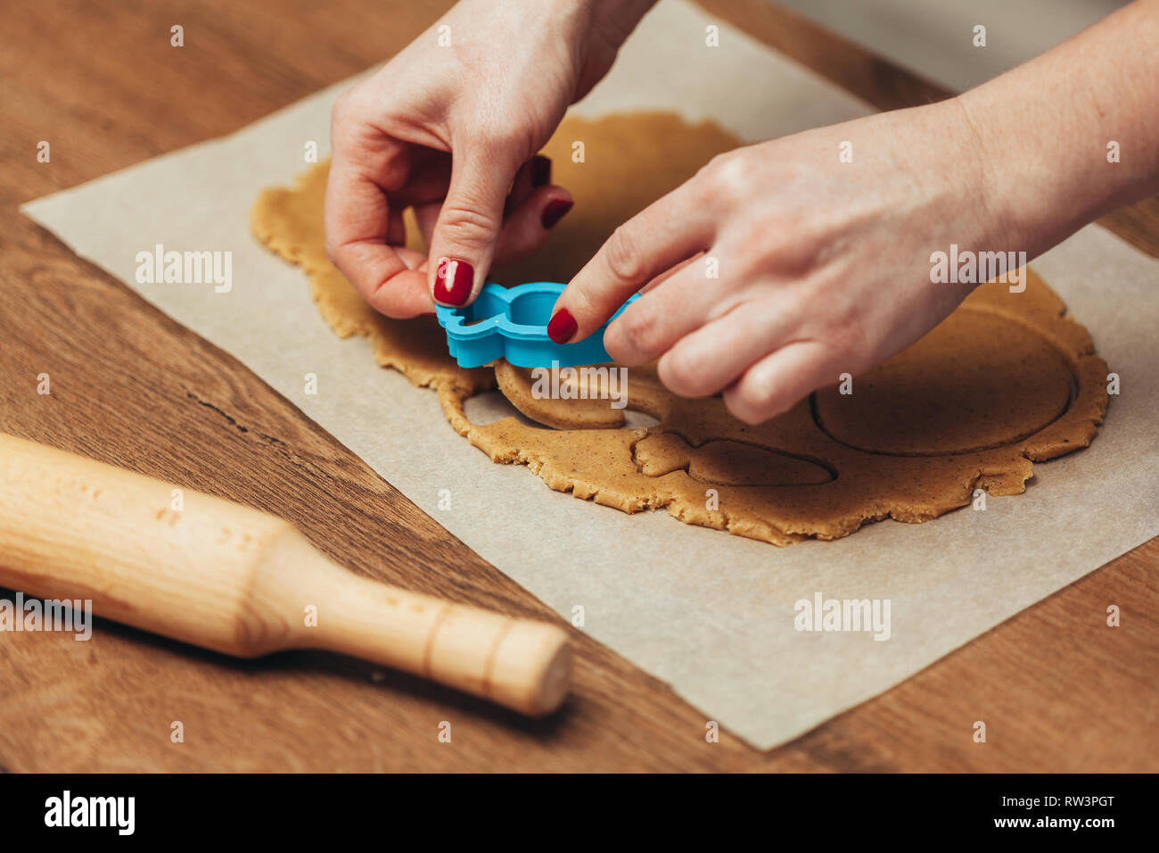 cooking and home concept - close up of female hands making cookies from ...
