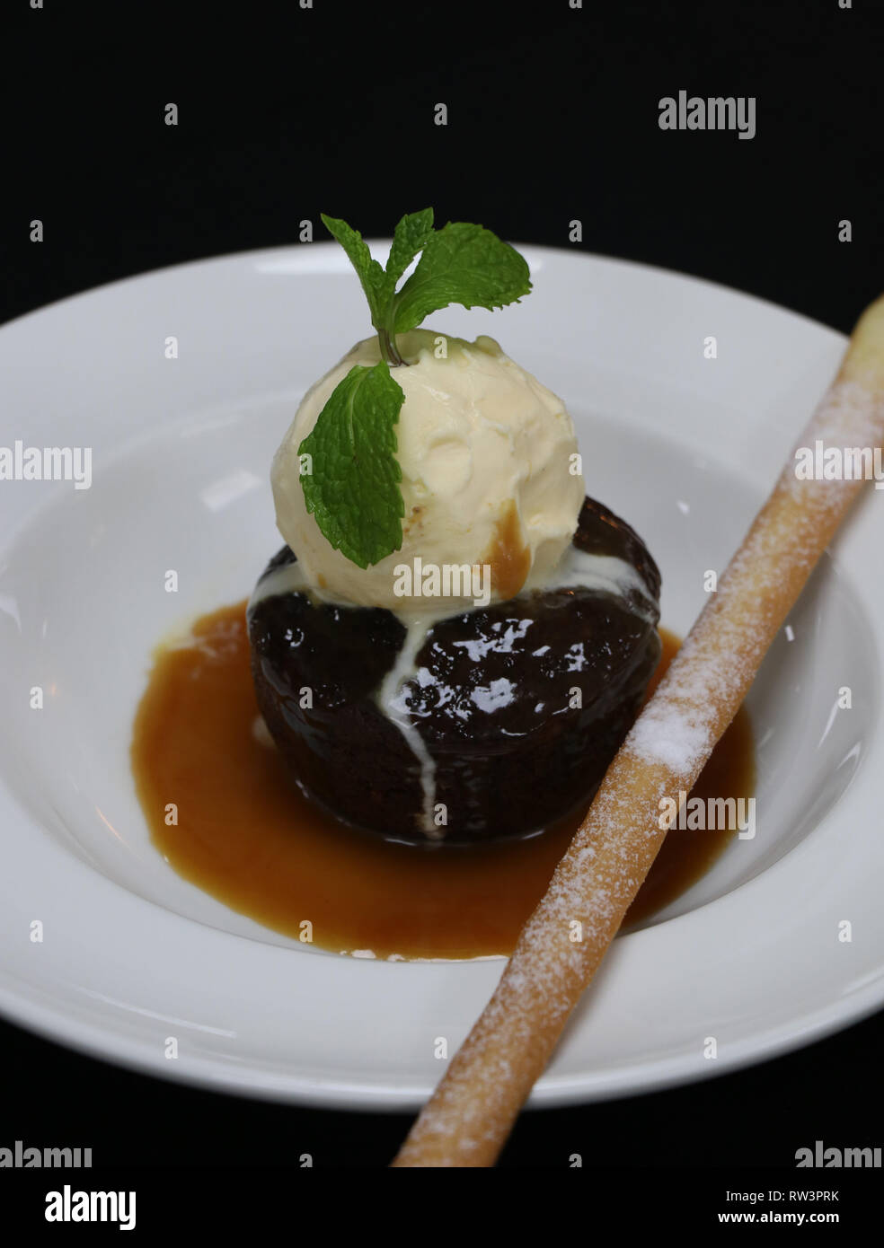 sticky toffee pudding with vanilla ice cream and caramel sauce Stock ...