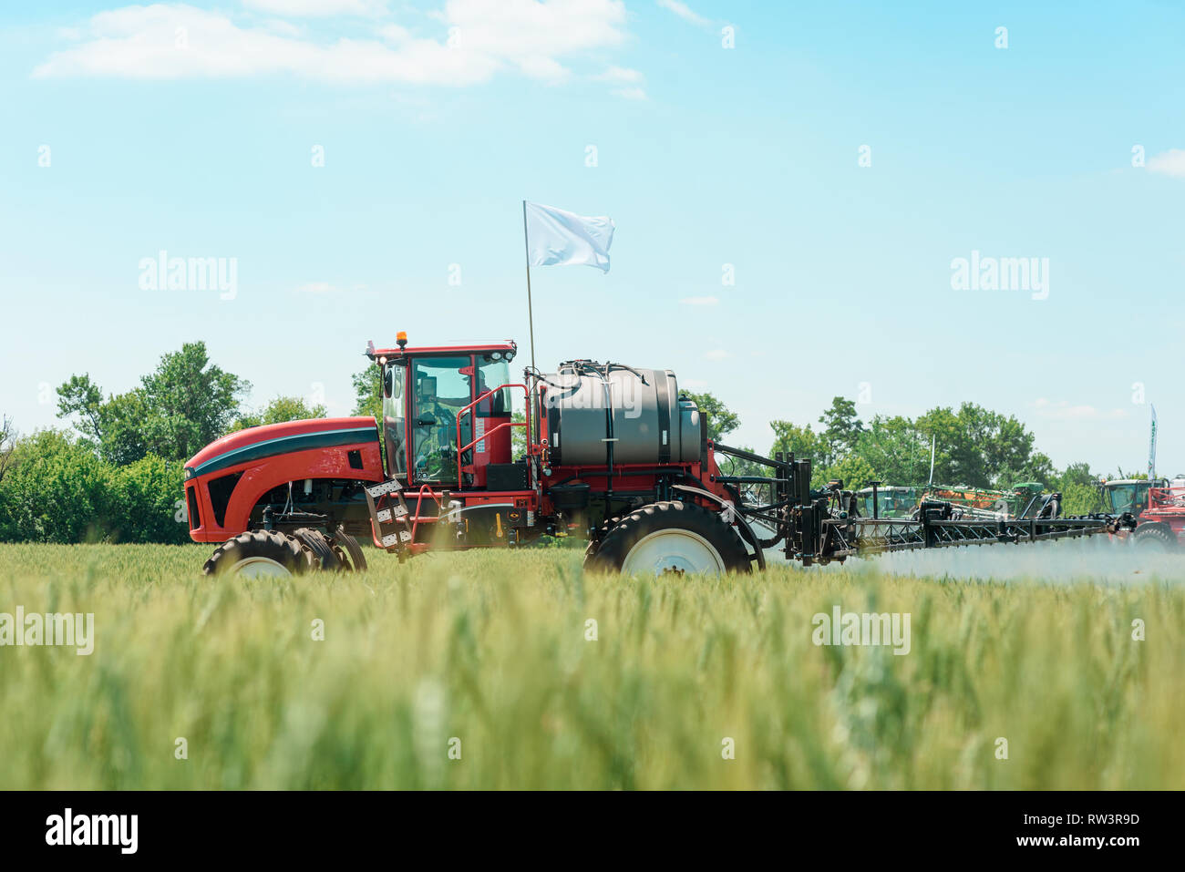 Self propelled sprayer watering wheat Stock Photo - Alamy