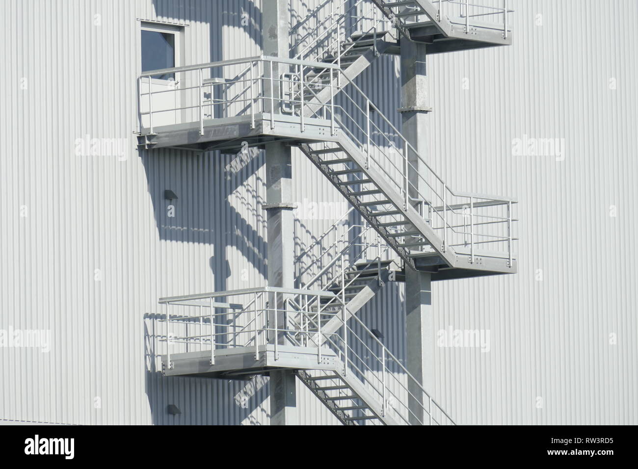 External staircase made of steel on a white factory building Stock ...