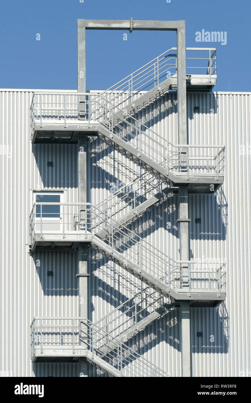External staircase made of steel on a white factory building Stock ...