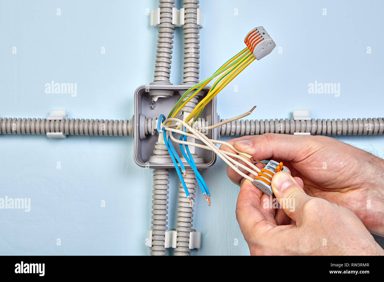 Electrician groups the wires together using spring terminals with ...