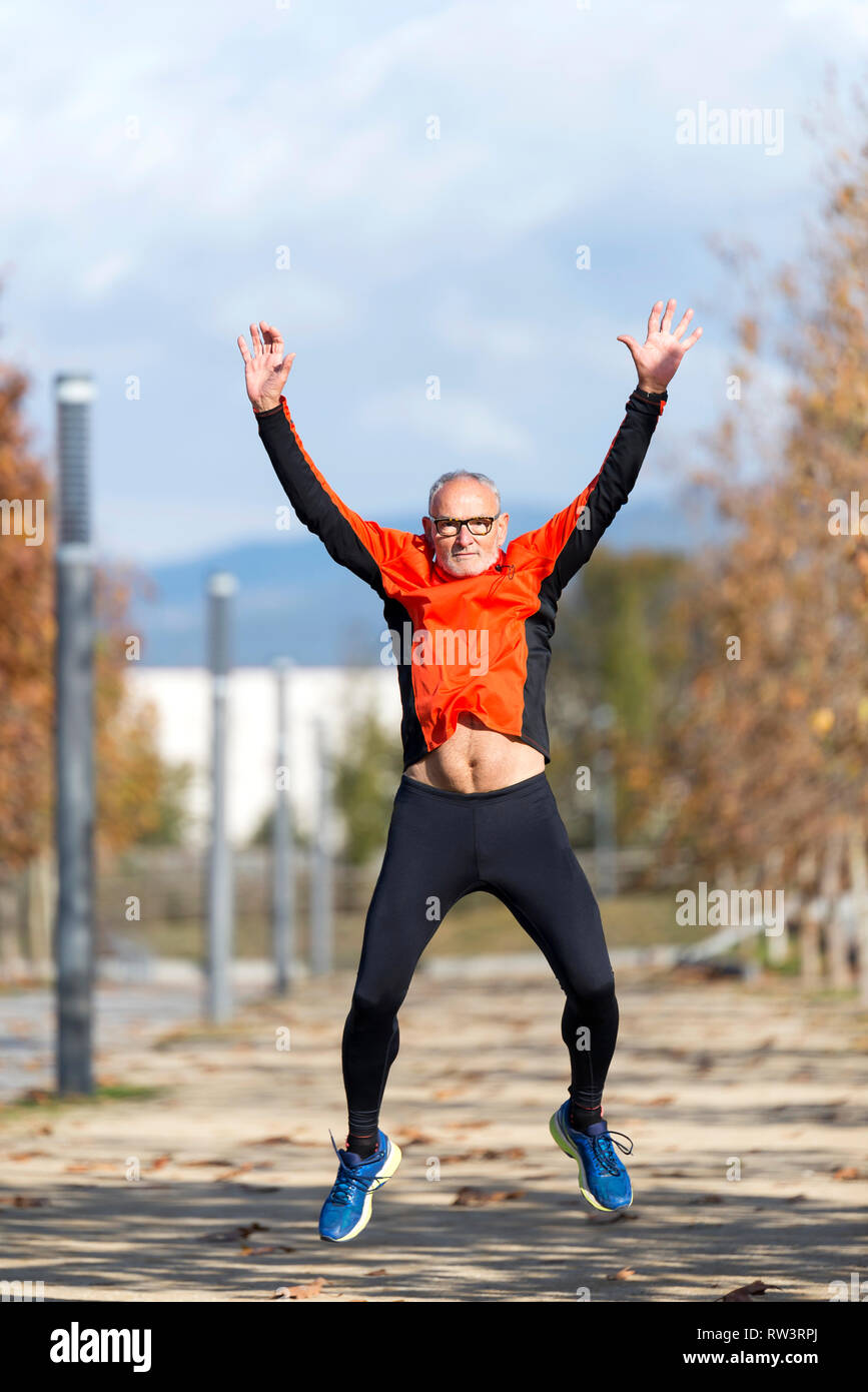 Runner arms up man hi-res stock photography and images - Alamy