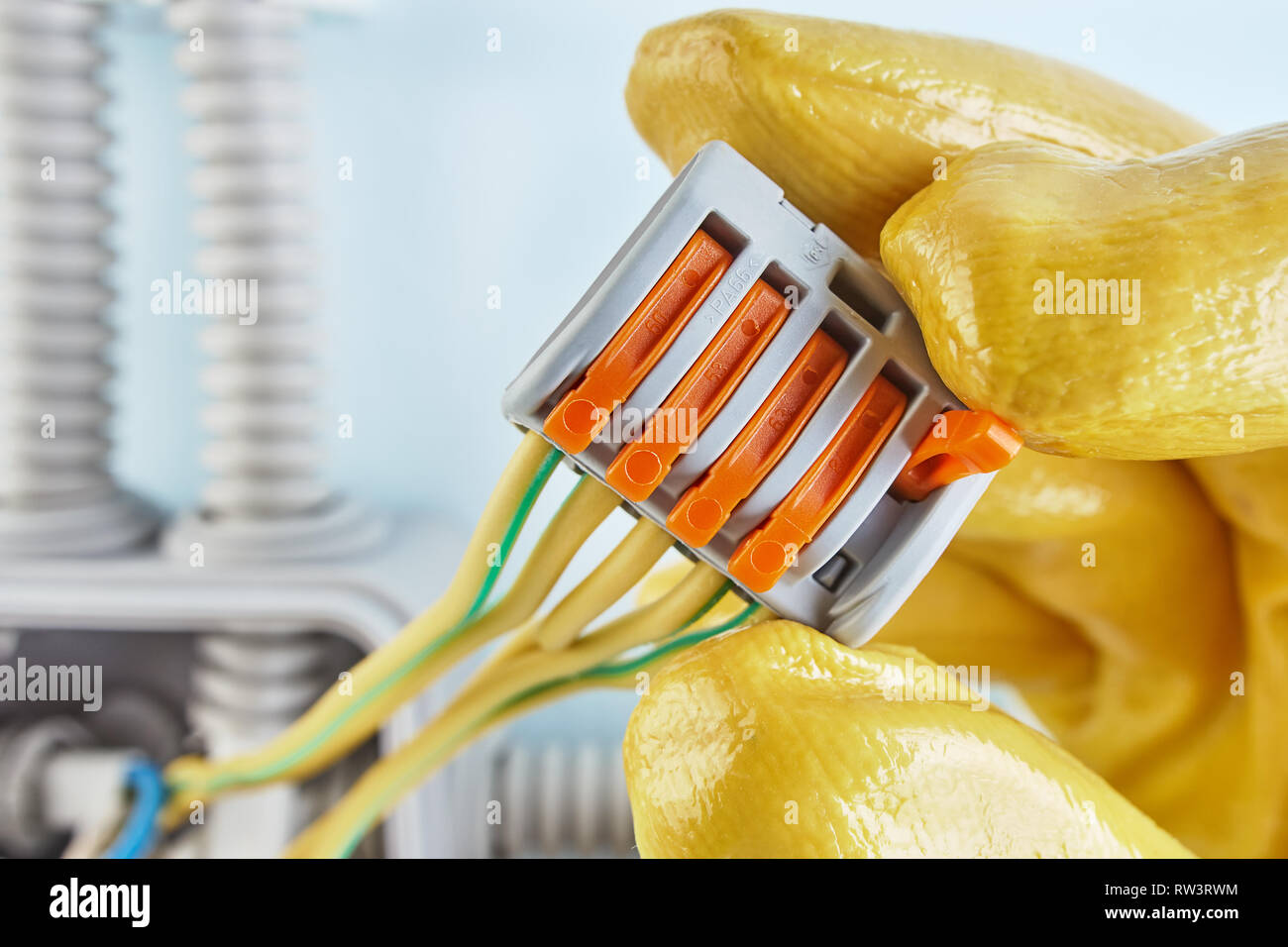 Compact connector 5-conductor terminal block with levers in hands in ...