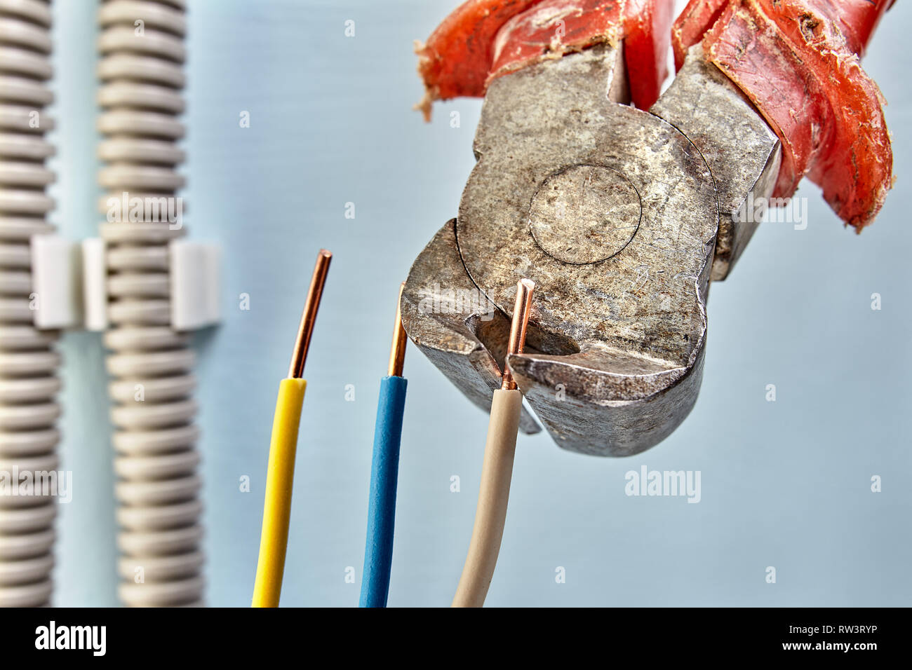 Electrical wiring installation with help of nippers tool, close-up ...