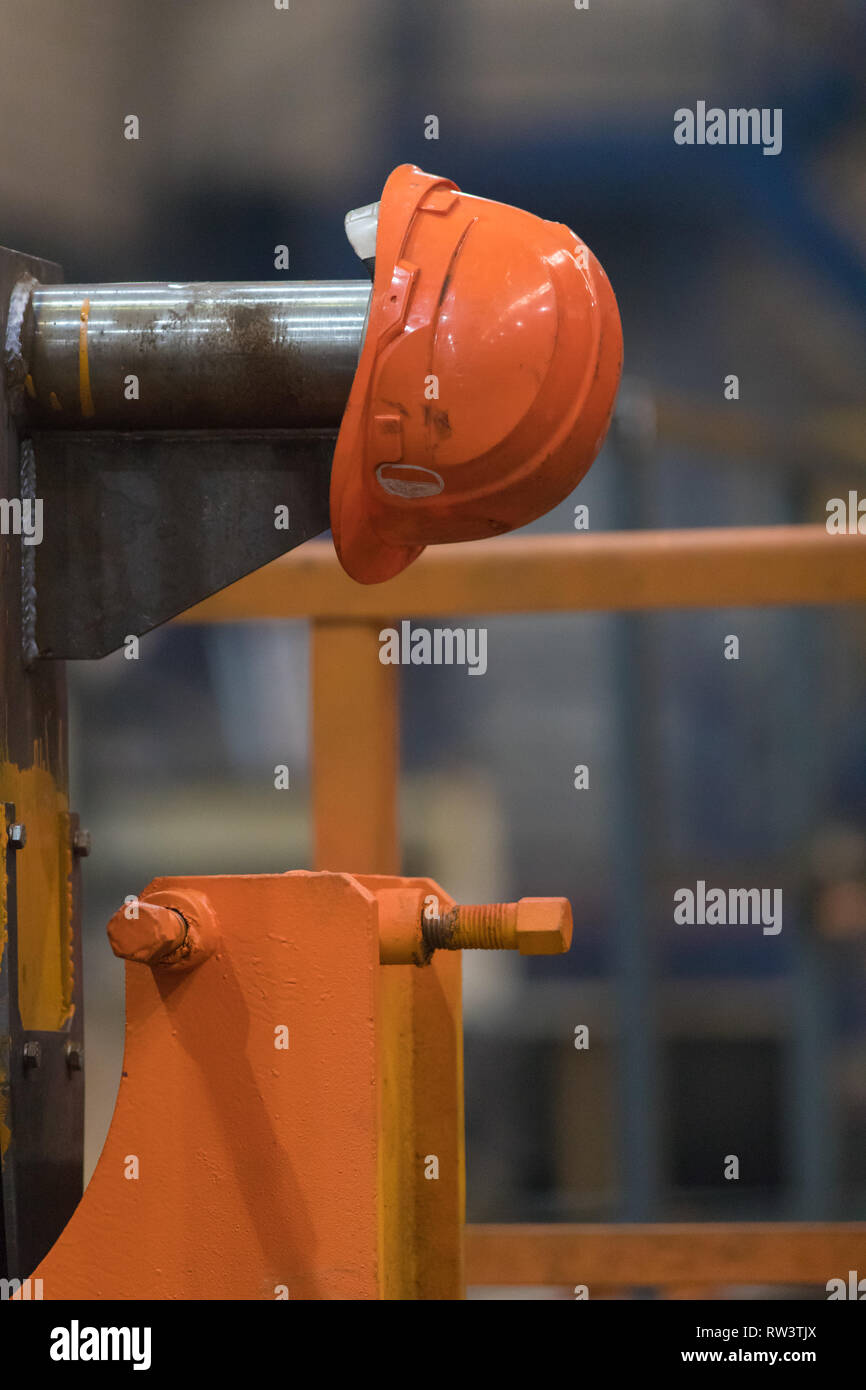 A helmet hanging on the iron detail Stock Photo - Alamy