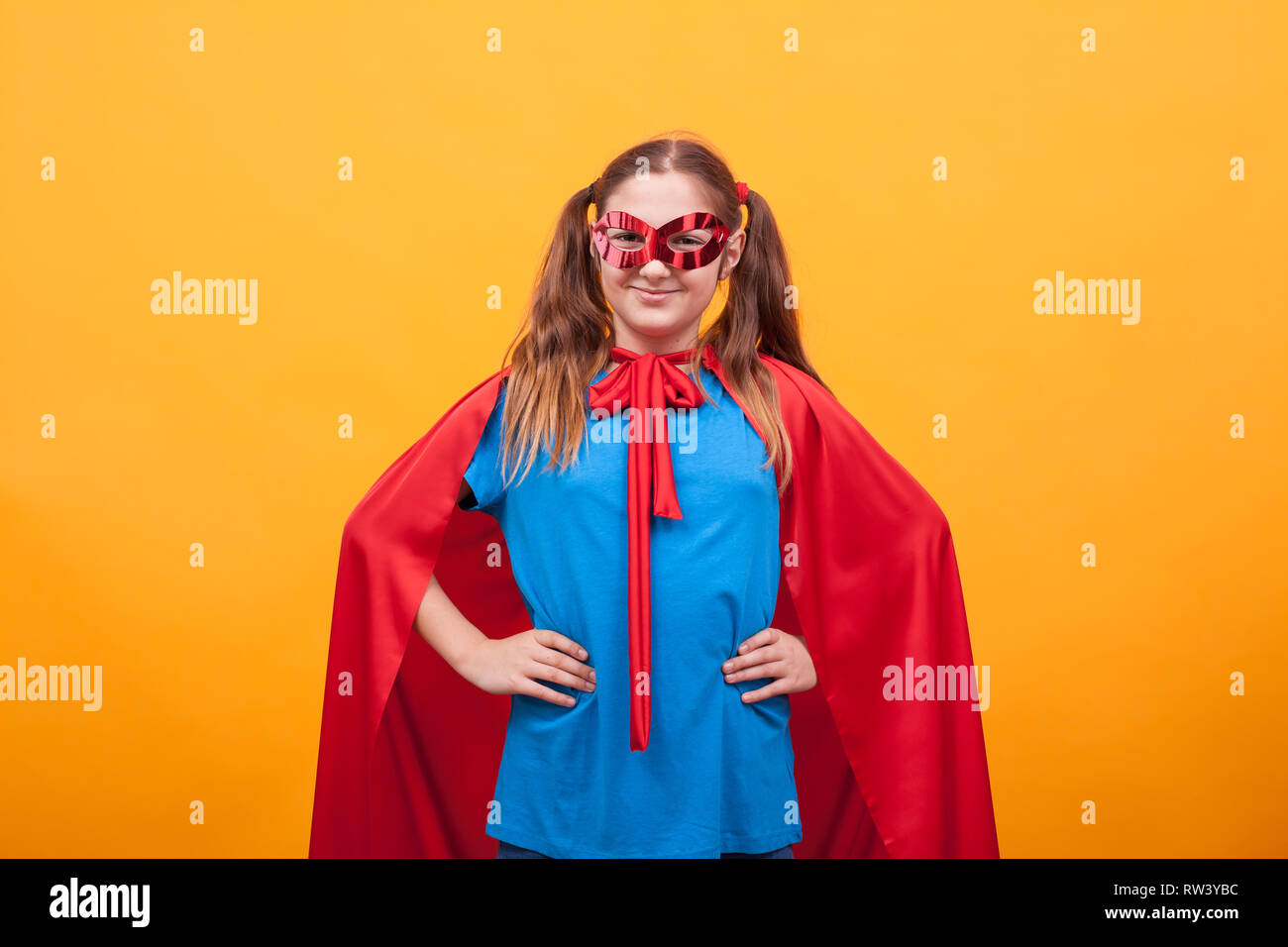 Little girl in super hero costume ready to save the world from bad guys ...