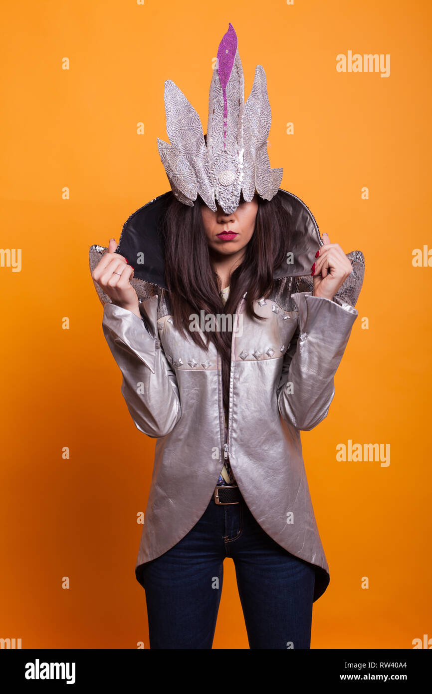 Woman dressed in witch halloween costume over yellow background.Voodoo ...