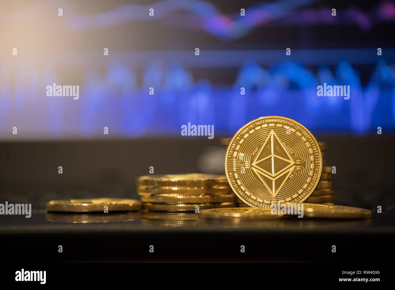 Ethereum gold coin and defocused chart background Stock Photo - Alamy