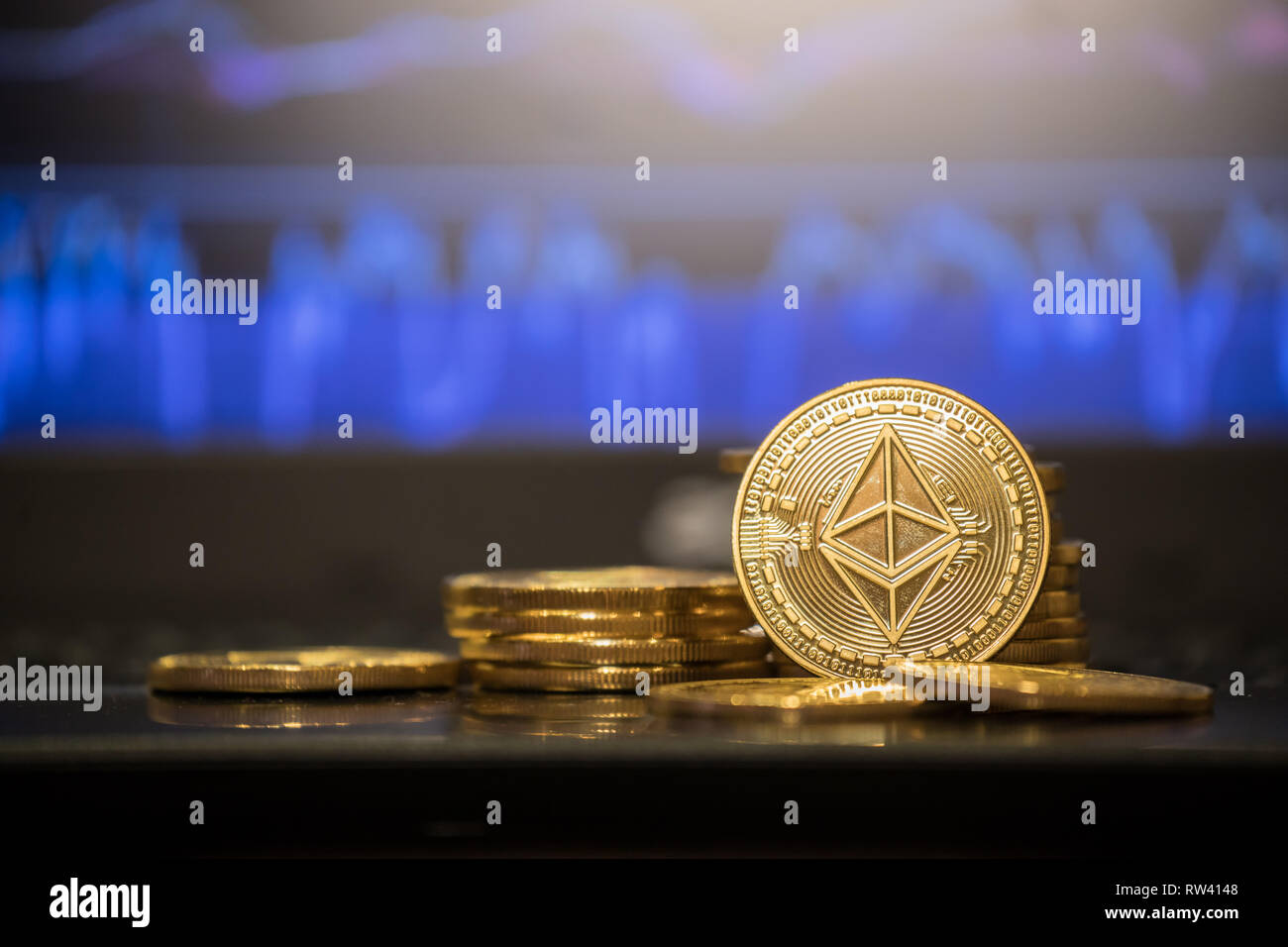 Ethereum gold coin and defocused chart background Stock Photo - Alamy