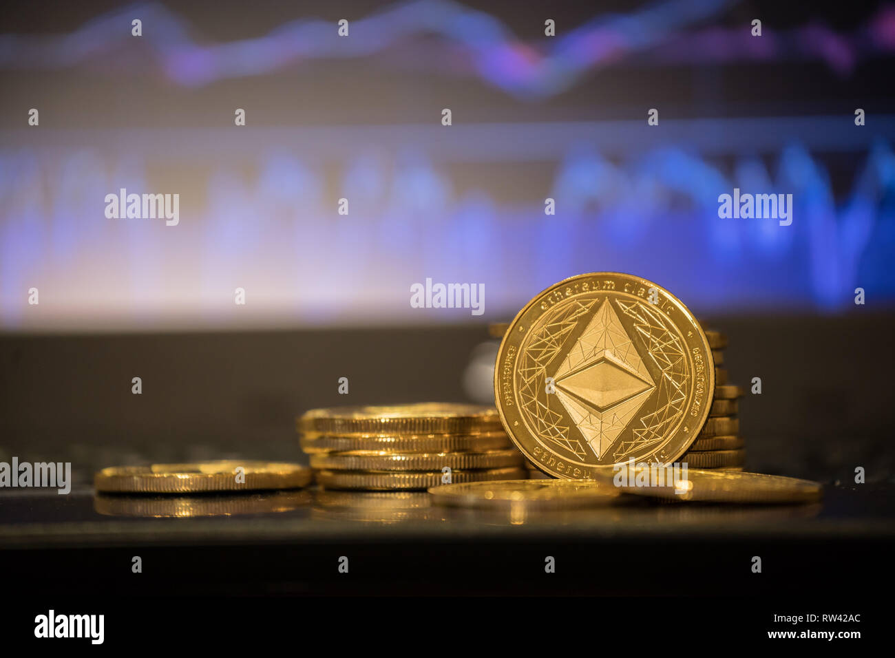 Ethereum gold coin and defocused chart background Stock Photo - Alamy
