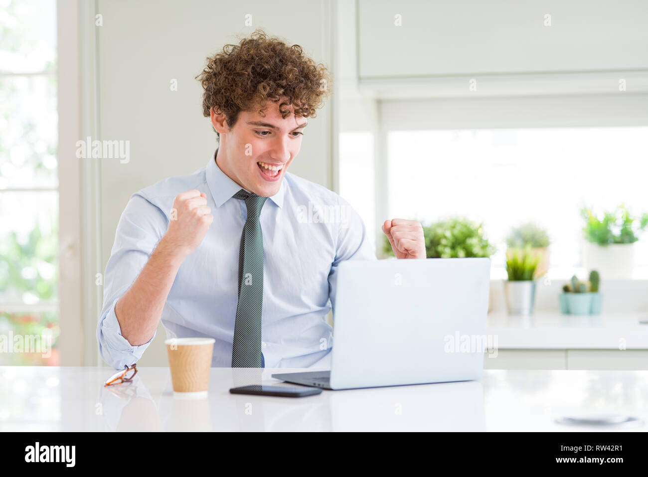 Young business man working with computer laptop at the office screaming ...