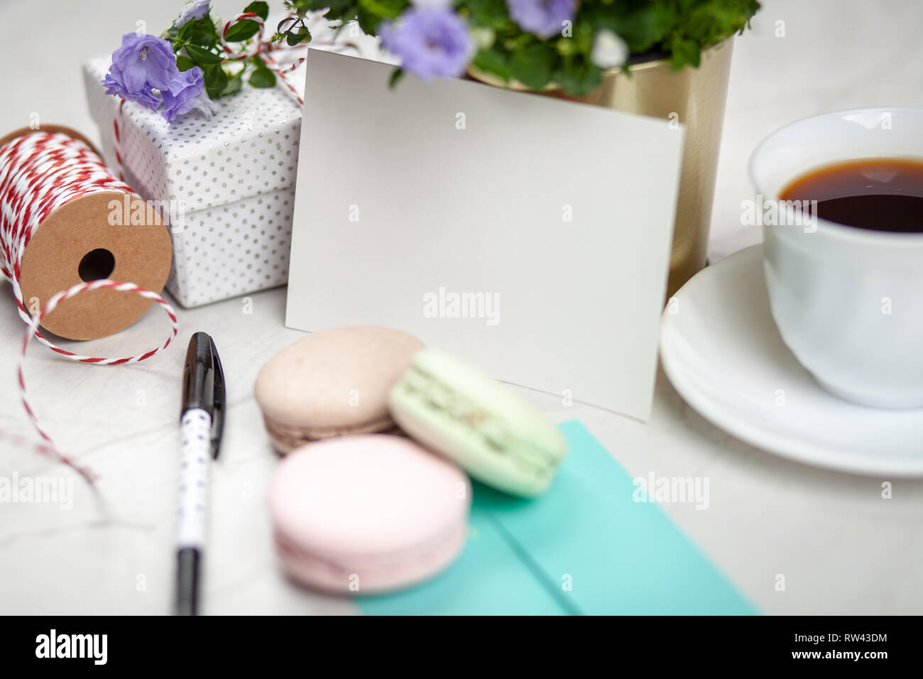 Writing a postcard on white marble table Stock Photo - Alamy