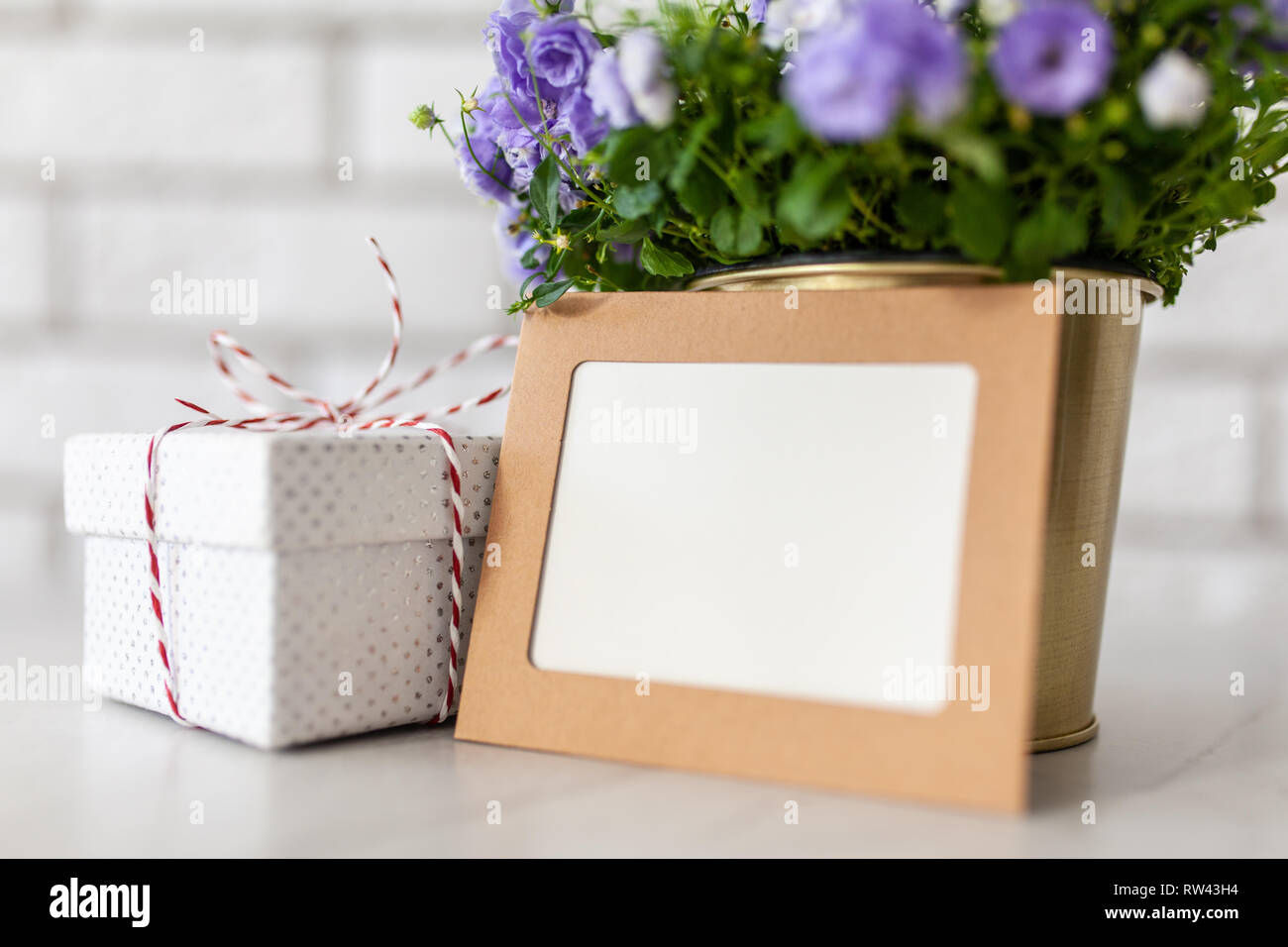 Gift boxes and flowers on white wall background Stock Photo - Alamy